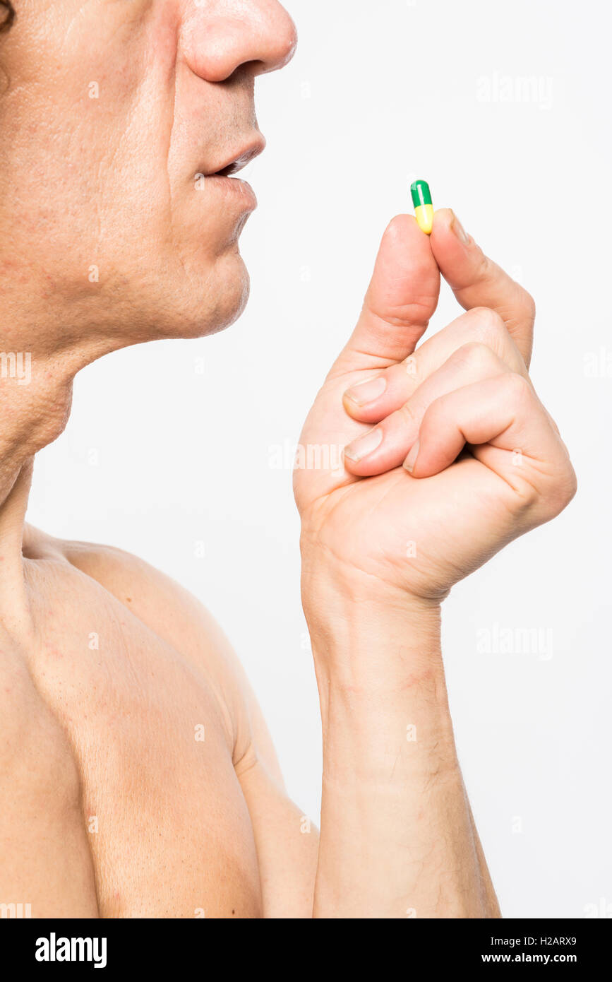 Man taking pill Stock Photo - Alamy