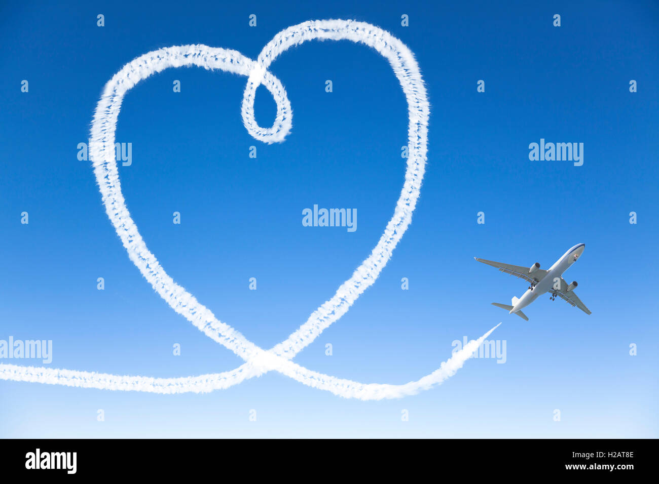 Airplane flying with the heart shape in the sky Stock Photo - Alamy