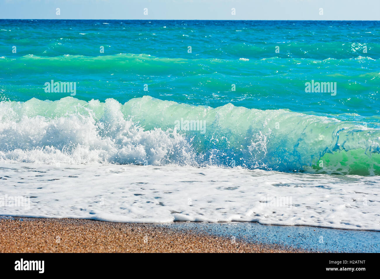 Strong foaming waves and beach Stock Photo - Alamy