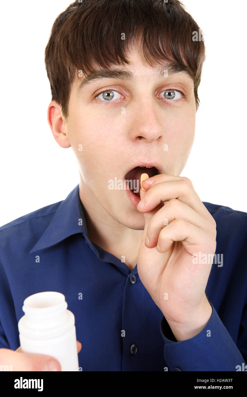 Handsome young man taking pill medicine capsule hi-res stock ...