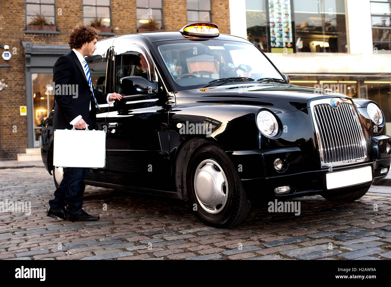 Businessman interacting with taxi driver Stock Photo - Alamy