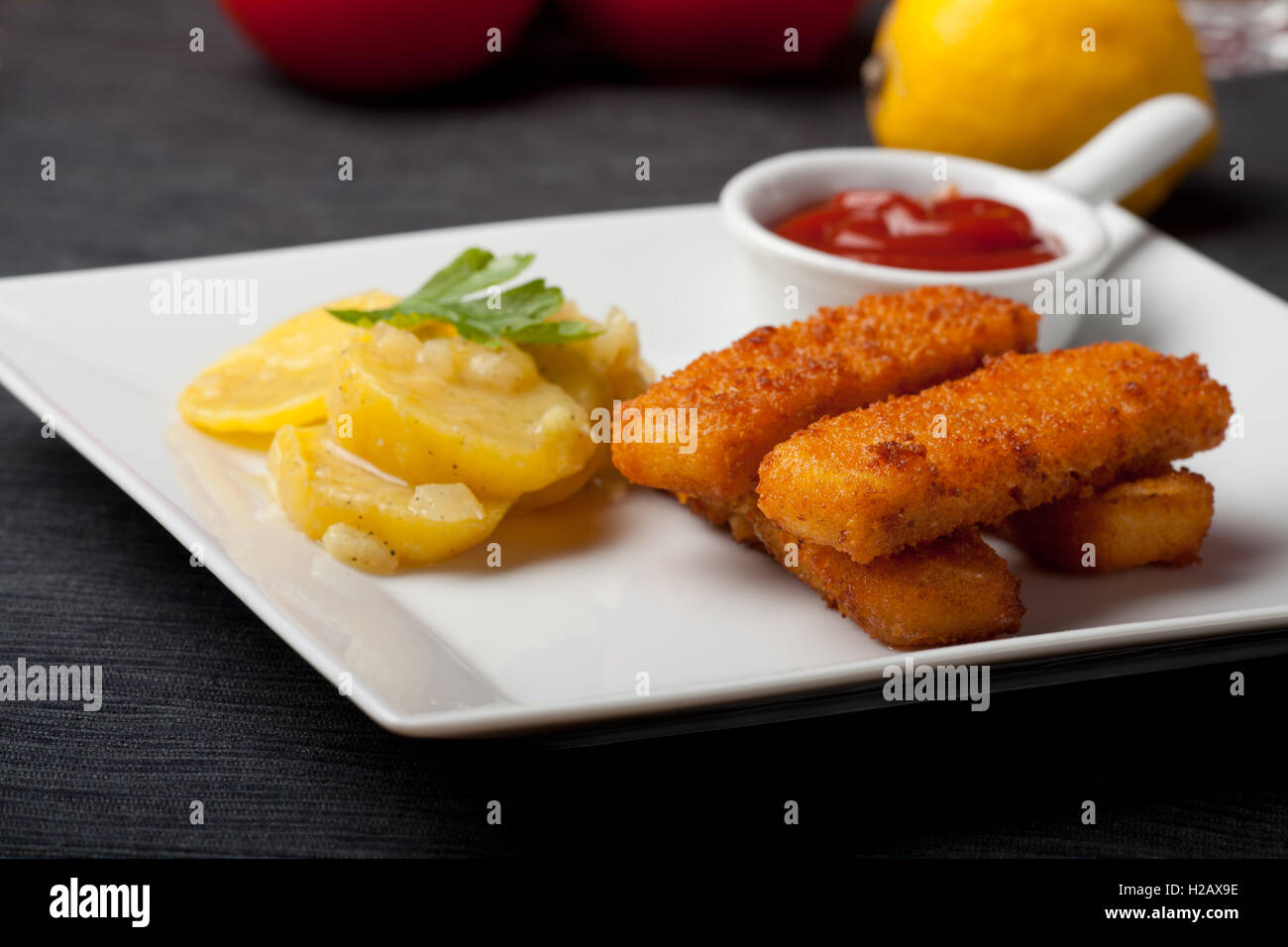 closeup of fish fingers with potato salad Stock Photo - Alamy