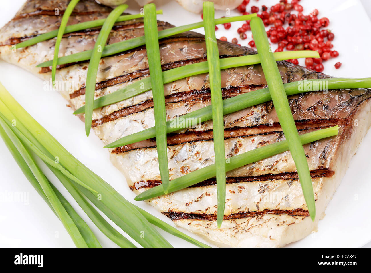 Grilled carp fillet on plate with onion Stock Photo - Alamy
