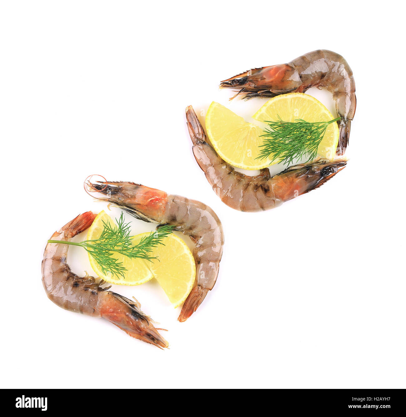 Four small raw shrimp with lemon Stock Photo - Alamy