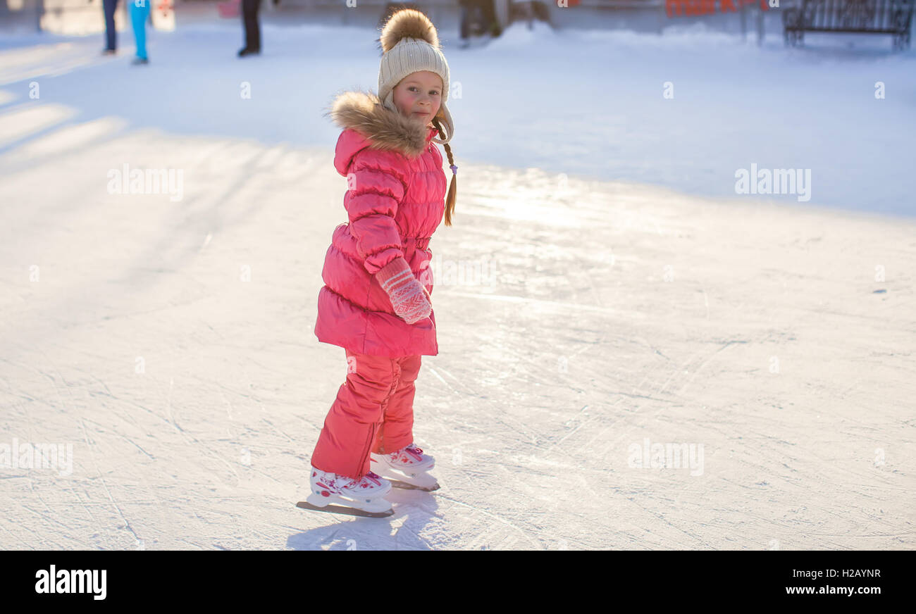 Adorable little girl enjoying skating at the ice-rink Stock Photo - Alamy