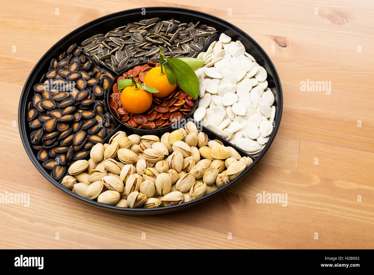 Chinese new year snack box and citrus fruit Stock Photo - Alamy