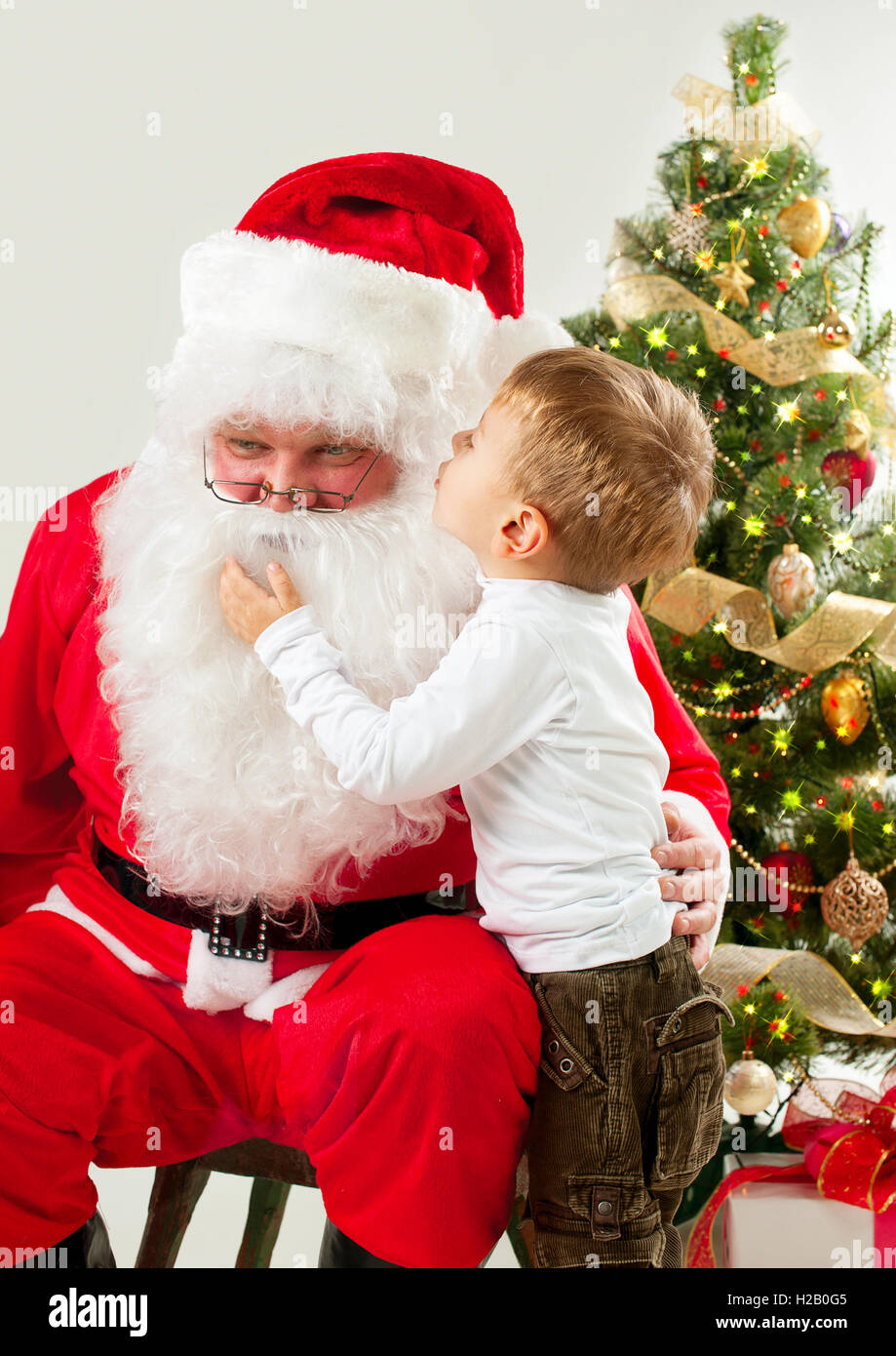 Santa Claus and Little Boy. Christmas Scene Stock Photo - Alamy