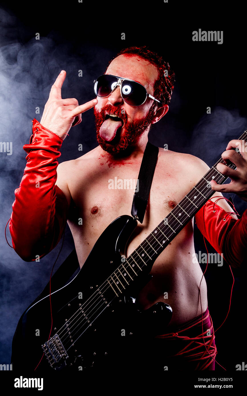 Player, guitarist with electric guitar black, wearing face paint Stock ...