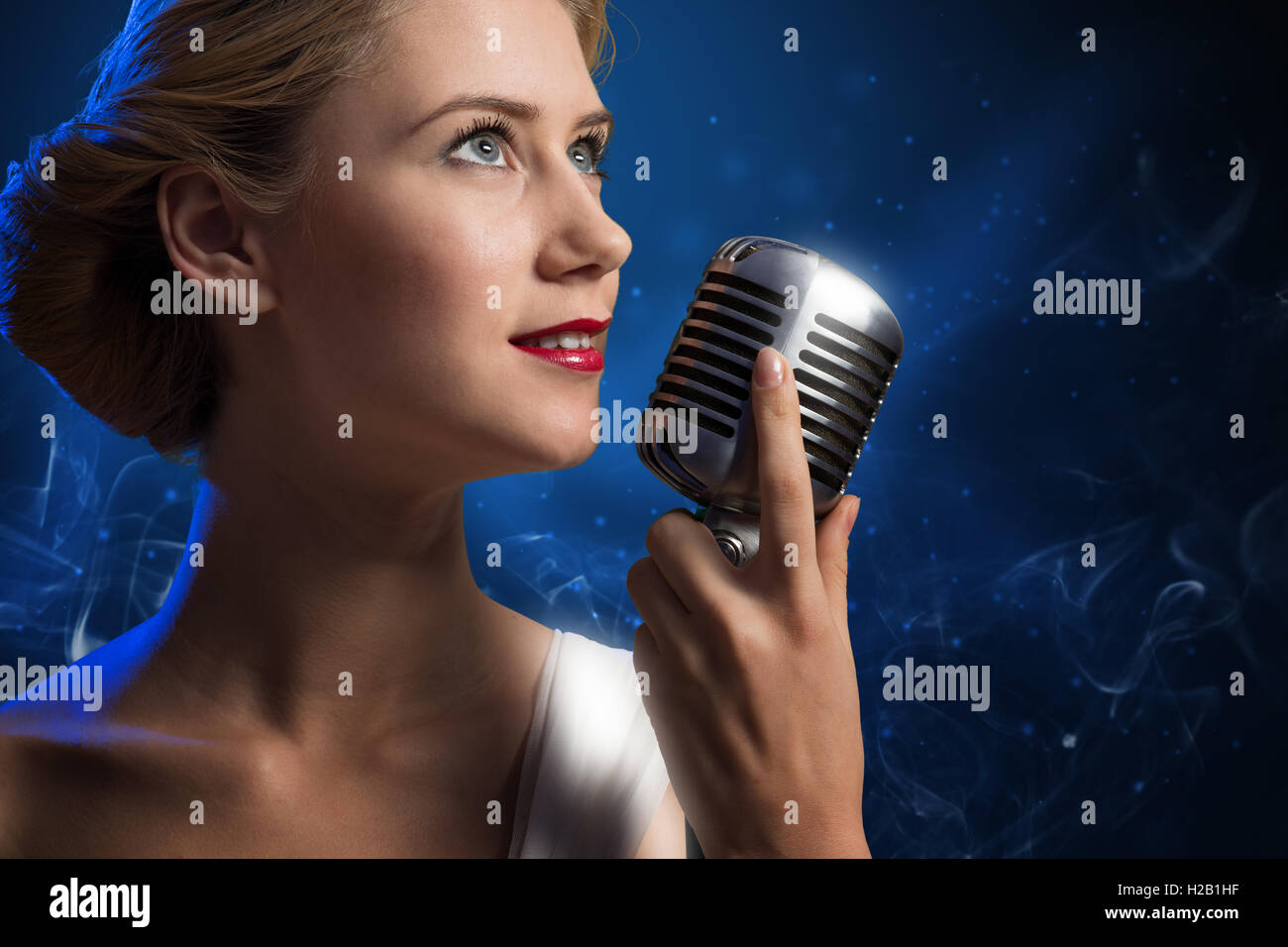 attractive female singer with microphone Stock Photo - Alamy