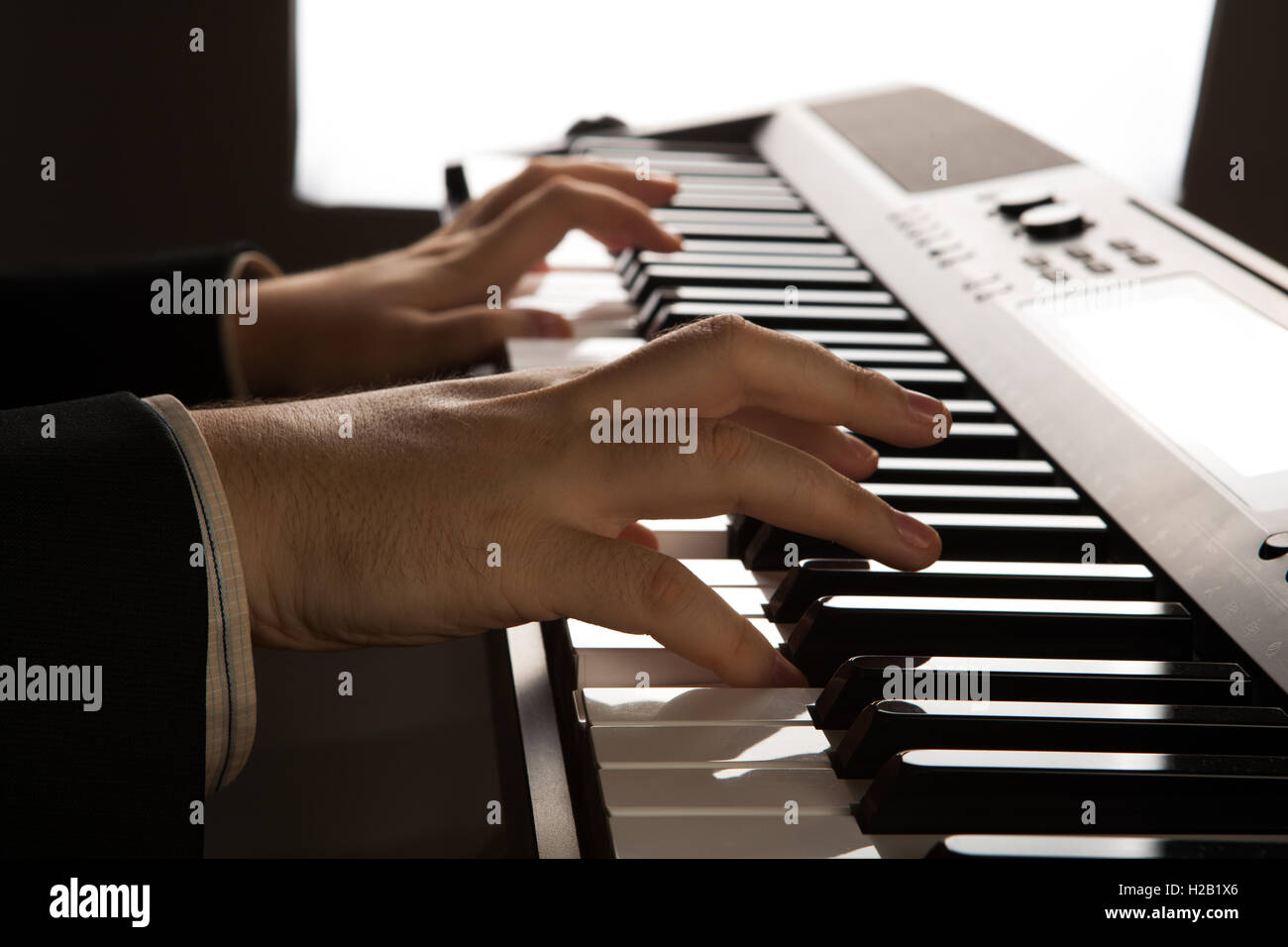 Piano keys and human hands Stock Photo - Alamy