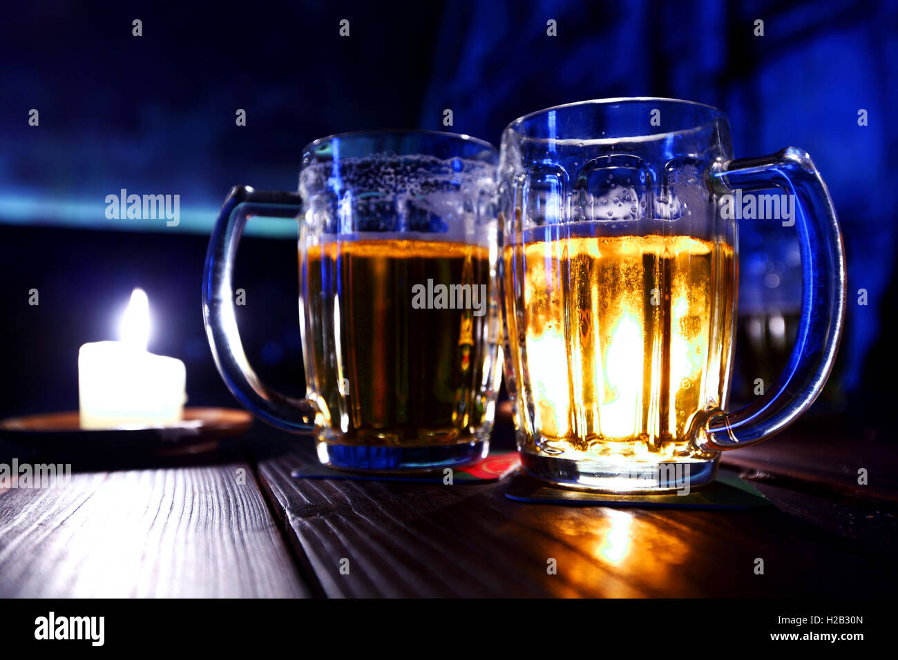 Two mugs of beer on table in bar Stock Photo - Alamy