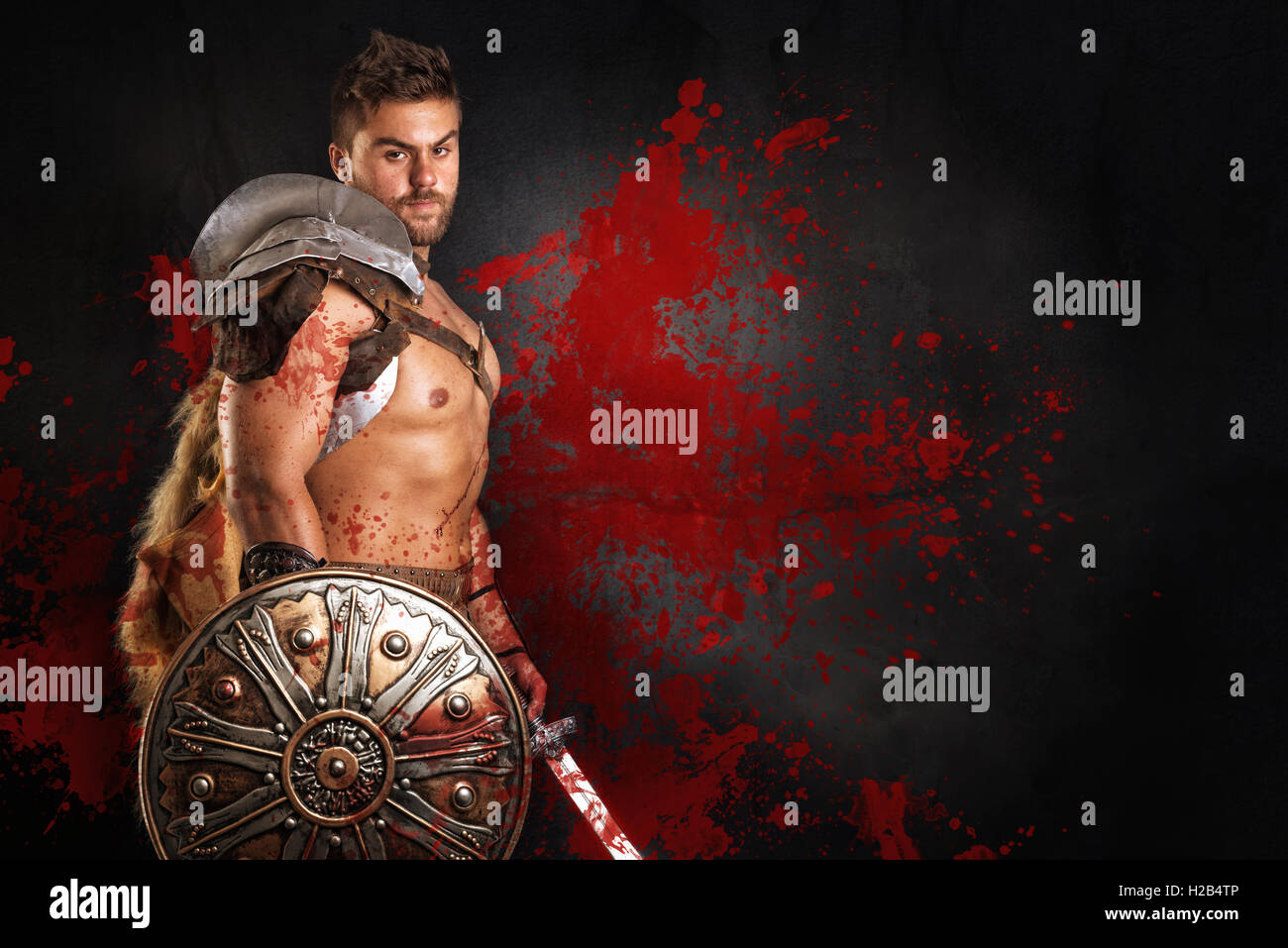 Ancient warrior or Gladiator posing over a dark background Stock Photo ...
