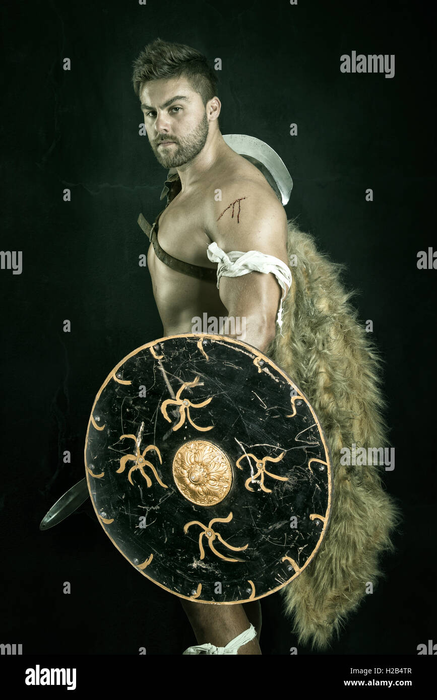 Ancient warrior or Gladiator posing over a dark background Stock Photo ...