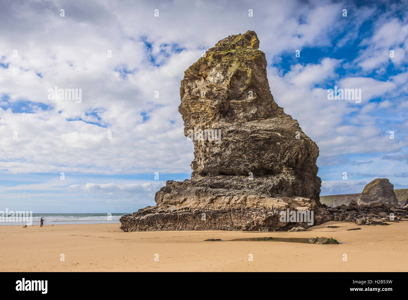One of the iconic rock stacks towers over tourists at Bedruthan Steps ...