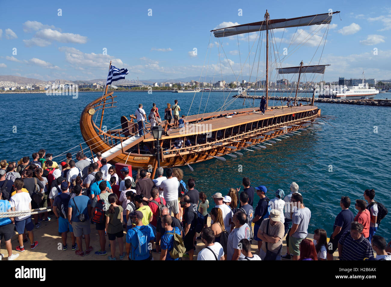 Volunteer rowers getting on board a full scale copy of an ancient ...