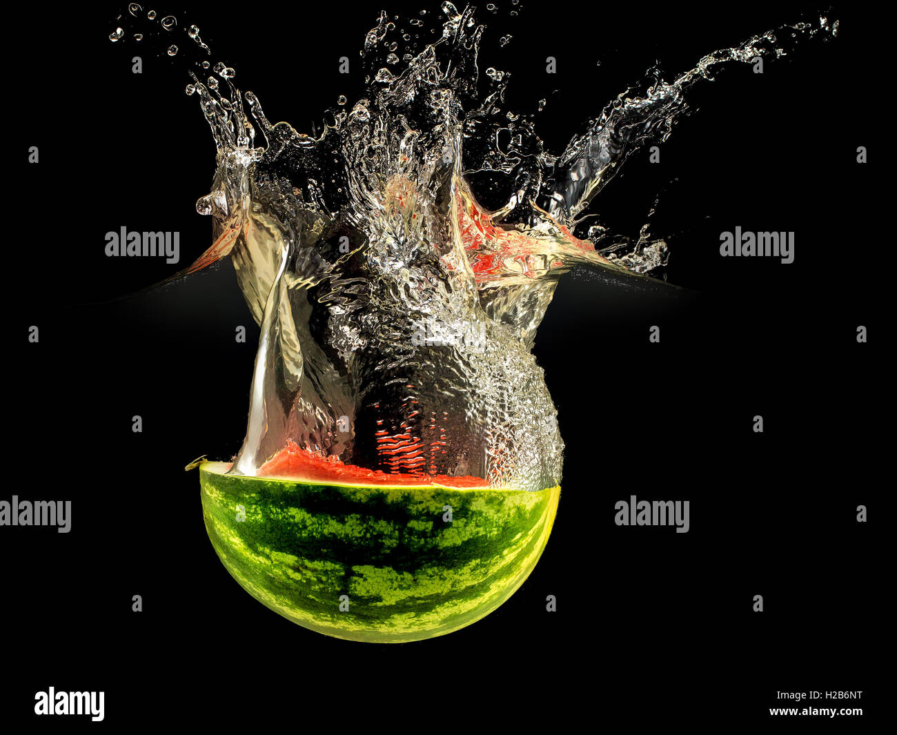 Fresh melon falling in water with splash on black background Stock ...