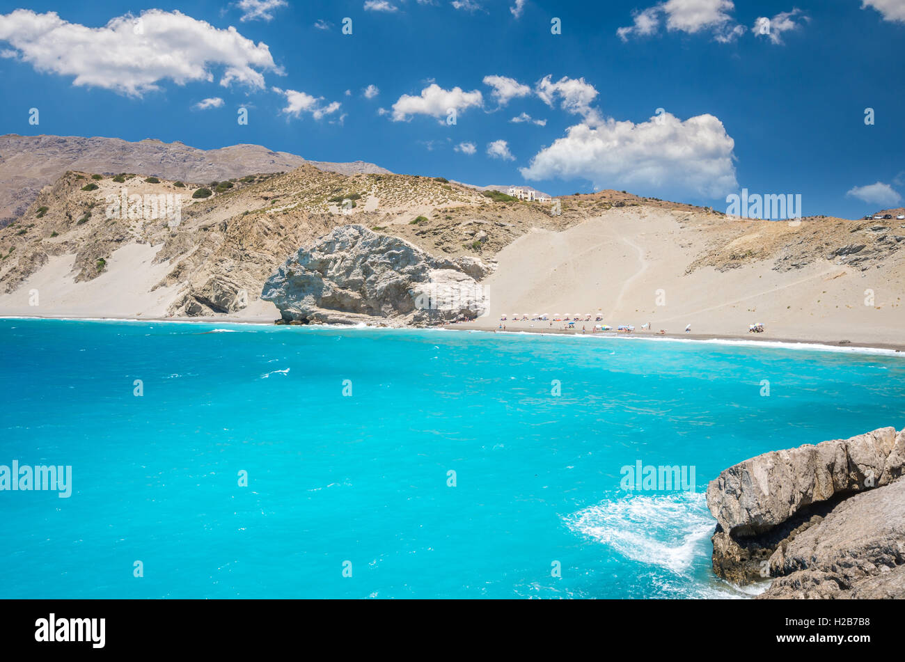 Agios Pavlos Beach in Crete island, Greece. Tourists relax and bath in crystal clear water of St ...