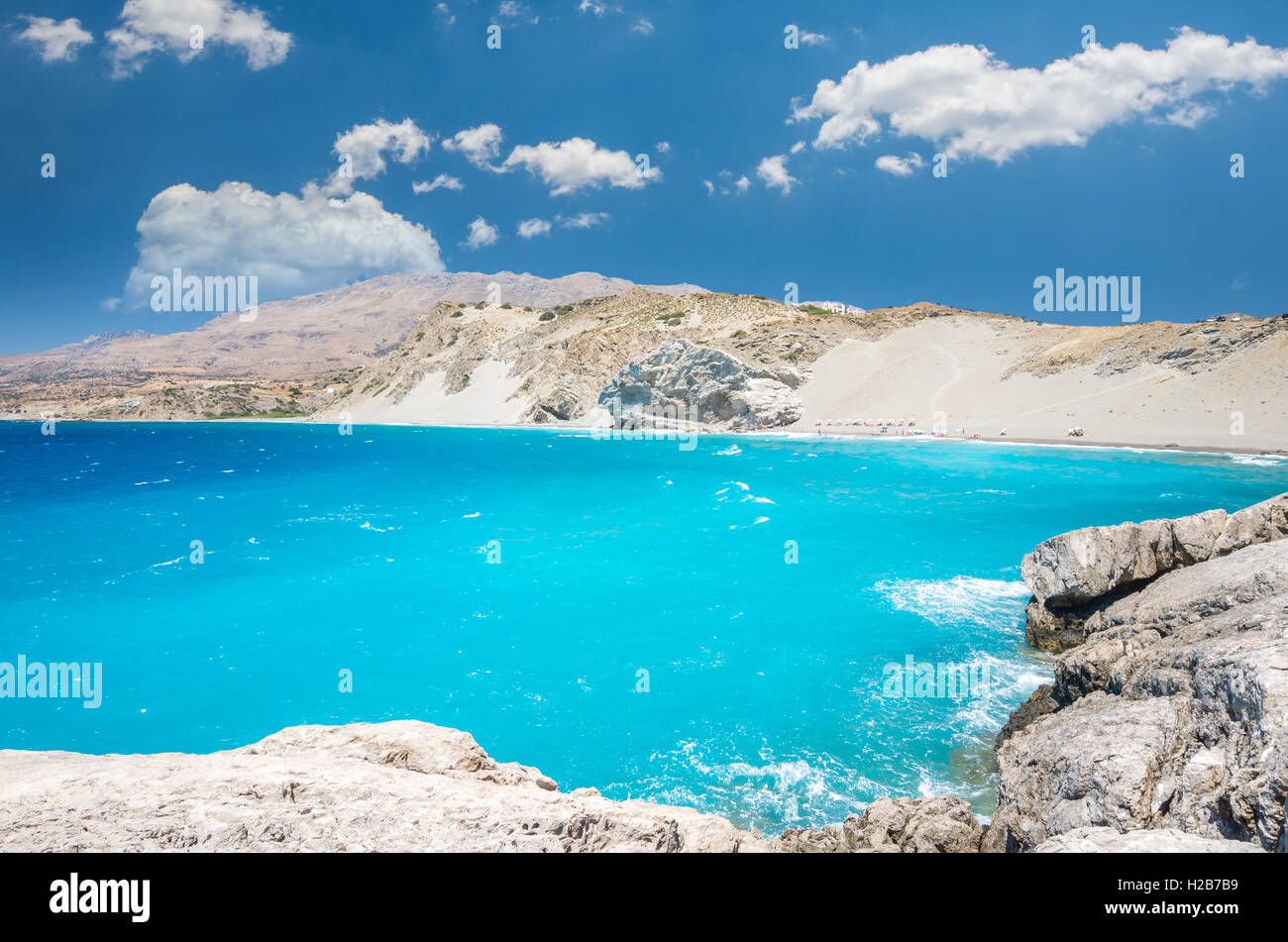 Agios Pavlos Beach in Crete island, Greece. Tourists relax and bath in crystal clear water of St ...