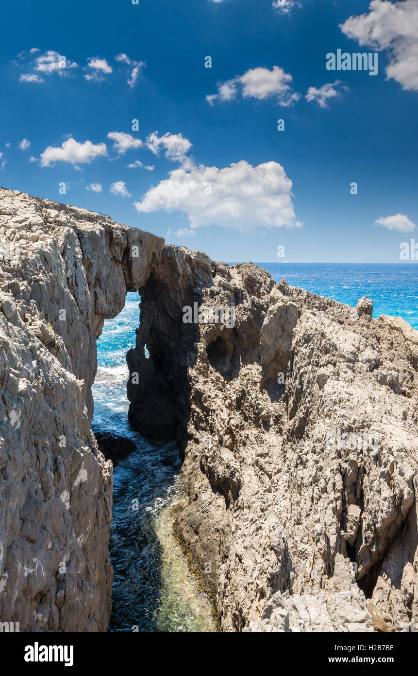 Agios Pavlos Beach in Crete island, Greece. Tourists relax and bath in crystal clear water of St ...