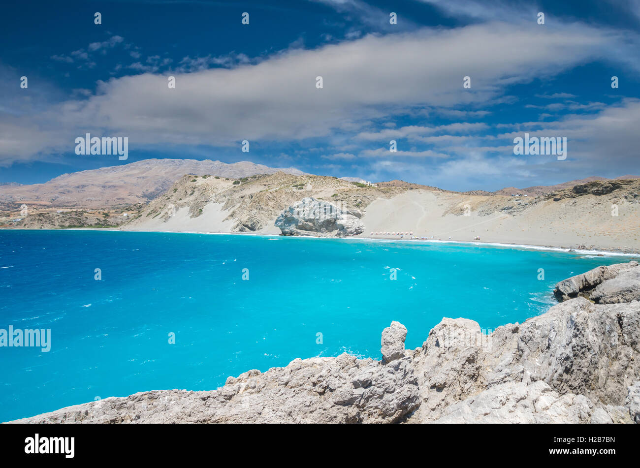 Agios Pavlos Beach in Crete island, Greece. Tourists relax and bath in crystal clear water of St ...
