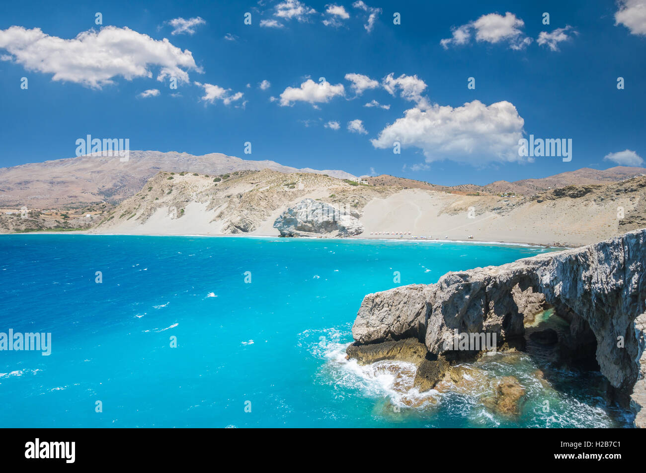 Agios Pavlos Beach in Crete island, Greece. Tourists relax and bath in crystal clear water of St ...