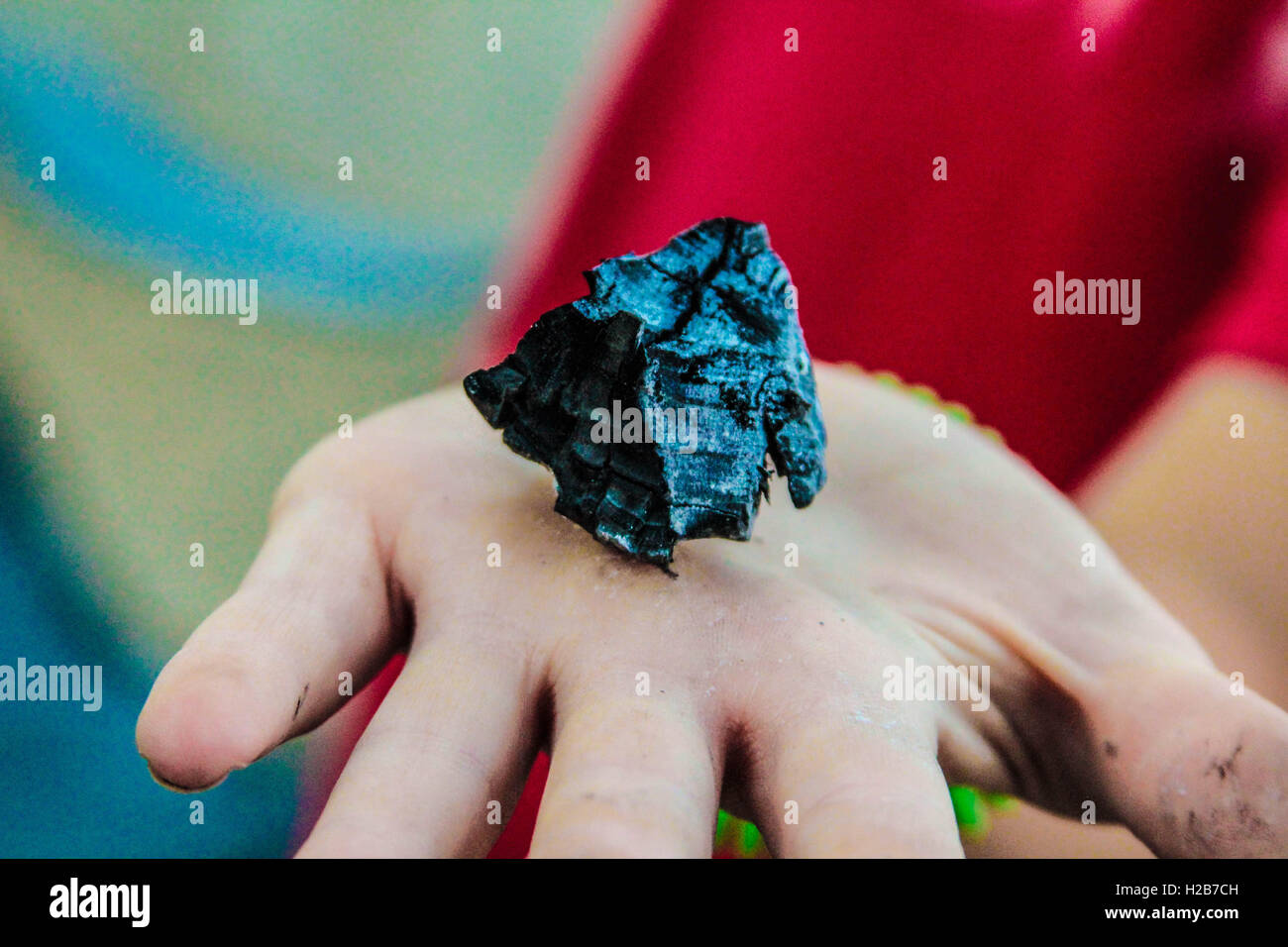 Child holding coal Stock Photo - Alamy