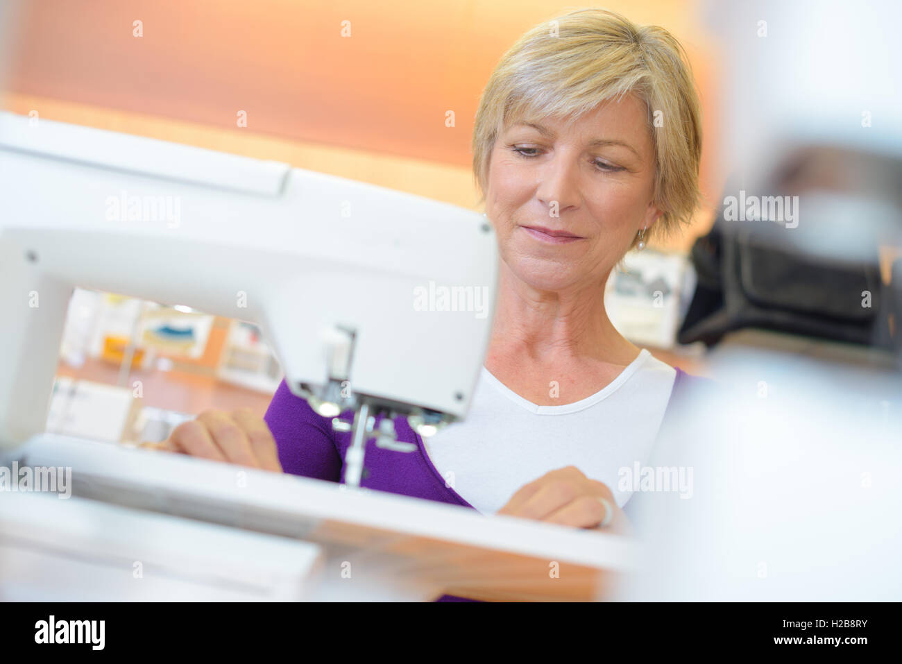 Mature woman working sewing machine hi-res stock photography and images - Alamy