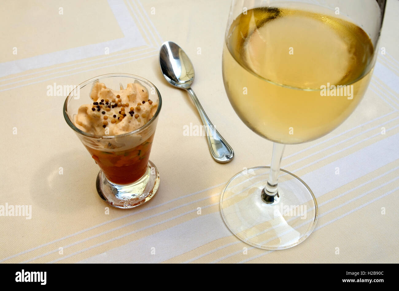 Savoury aperitif amuse bouche of tomato jus and prawn mousseline with ...