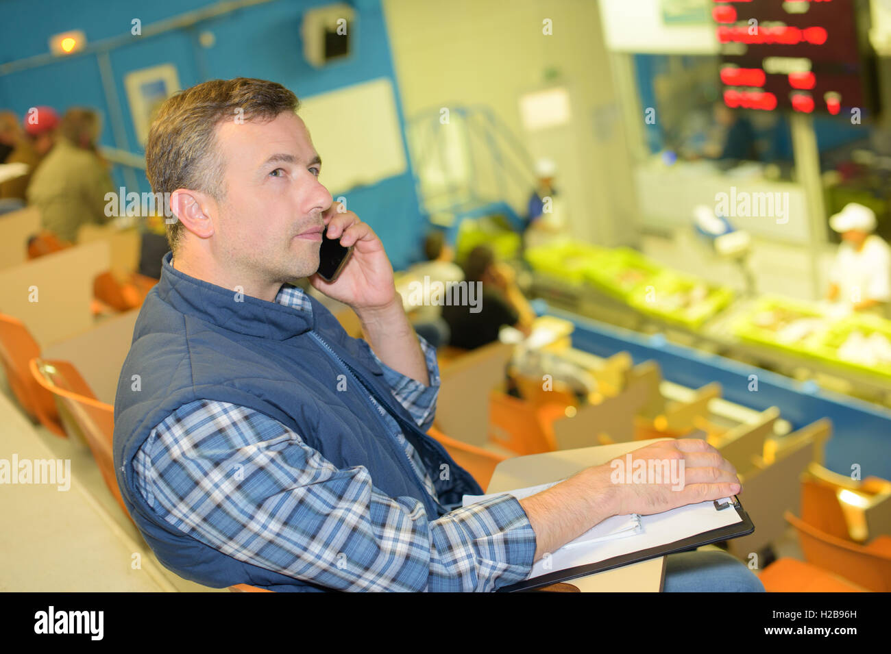 Man at an indoor auction Stock Photo - Alamy