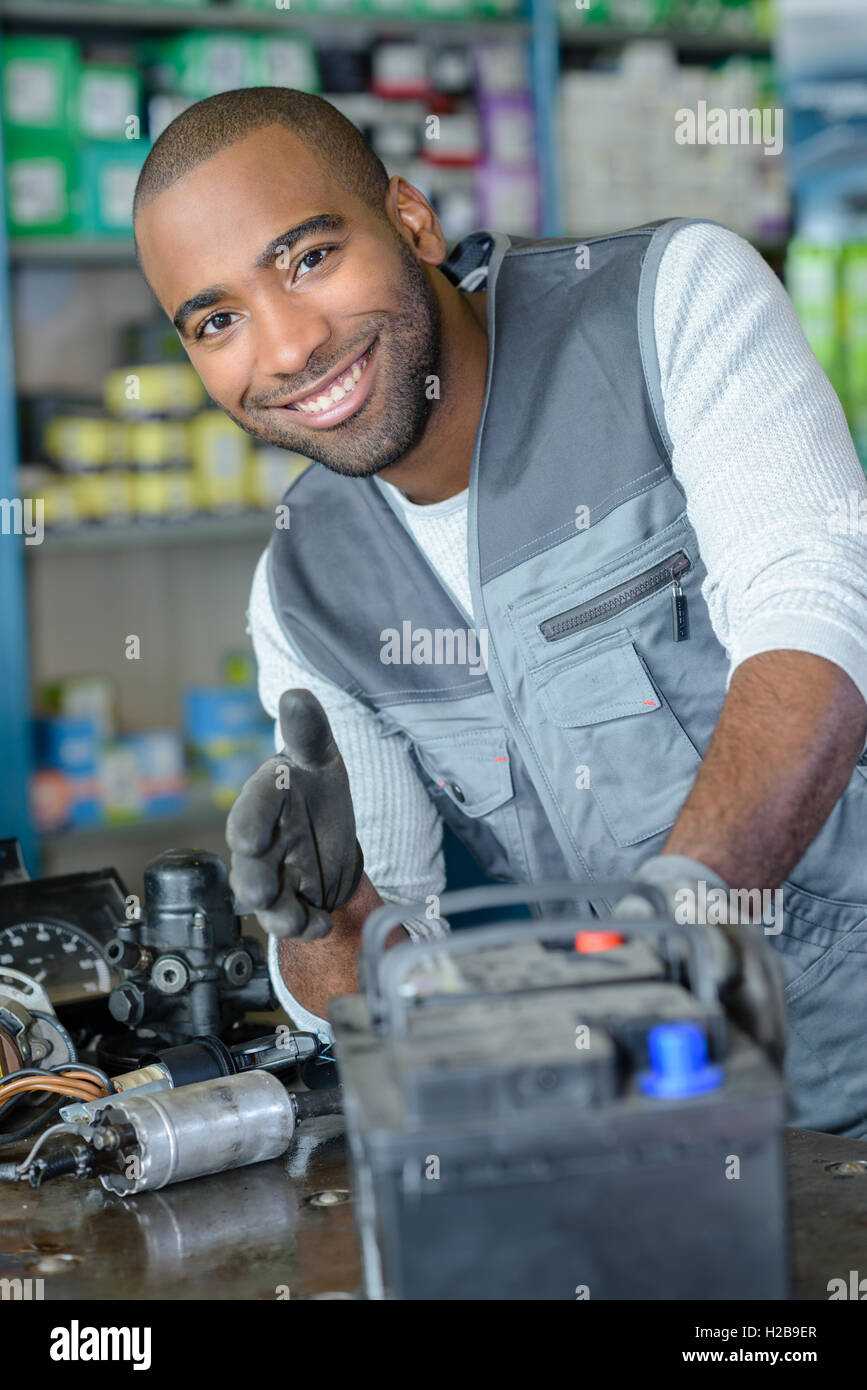 Portrait of man with car battery Stock Photo - Alamy