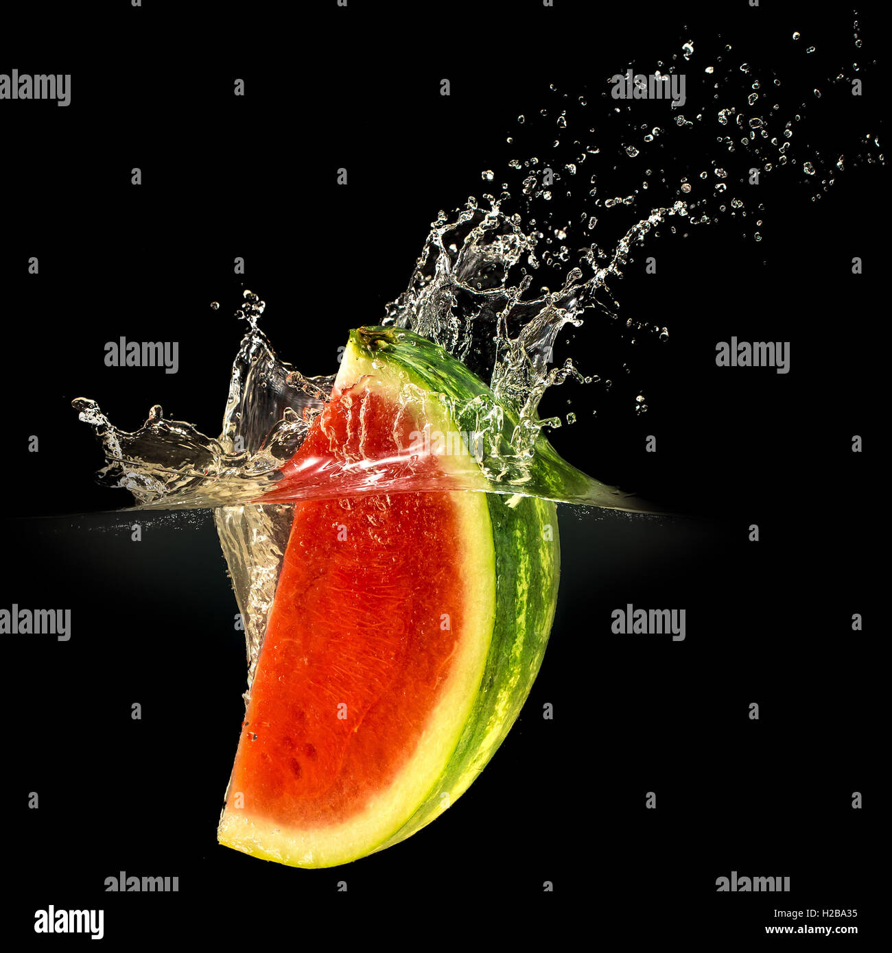 Fresh melon falling in water with splash on black background Stock ...