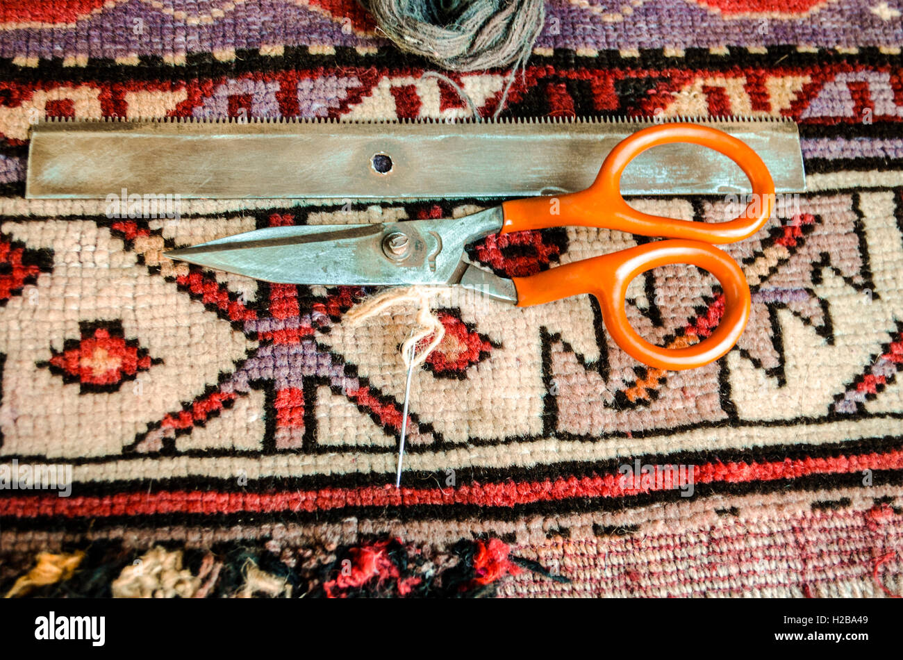 Restoration of the old wool handmade rug Stock Photo - Alamy
