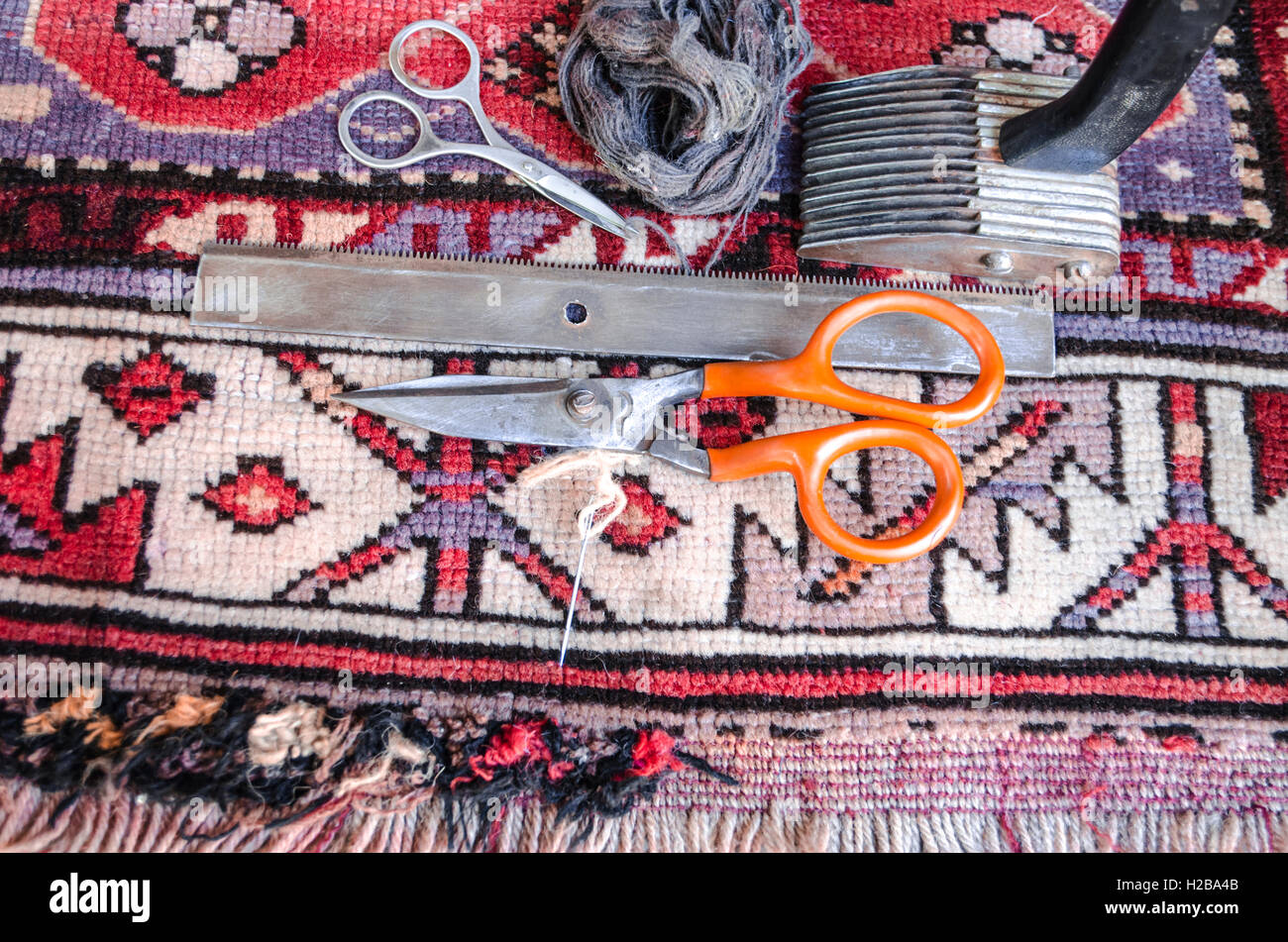 Restoration of the old woolen carpet Stock Photo - Alamy