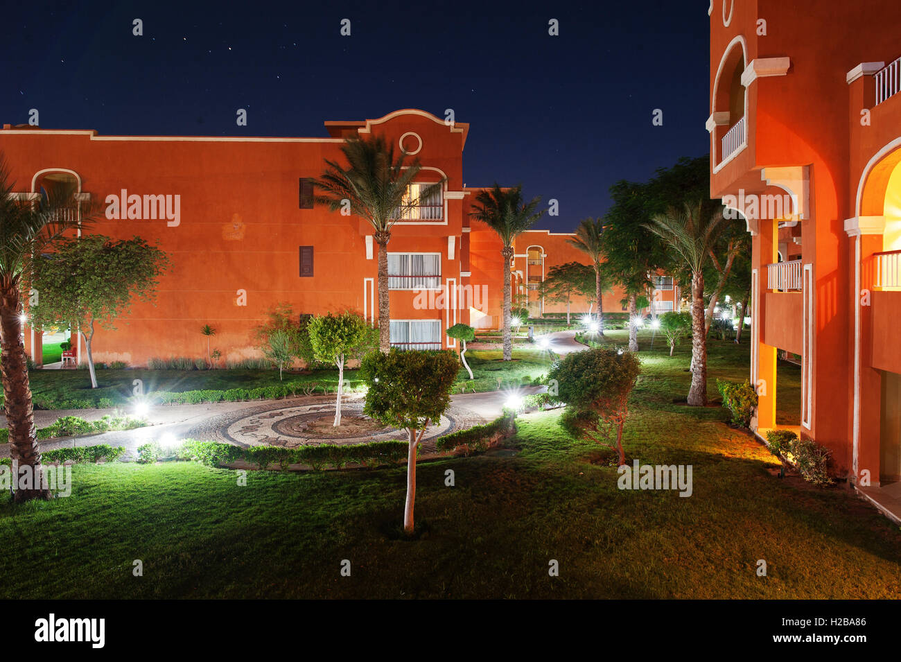 Luxury arabian resort house with garden at night view Stock Photo - Alamy