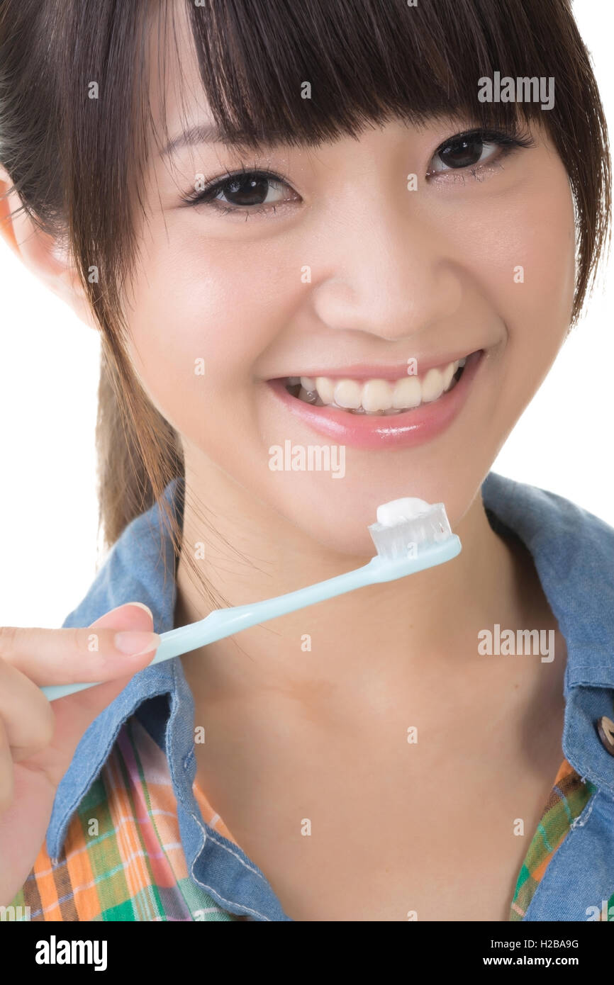 Attractive Asian young woman using toothbrush Stock Photo - Alamy