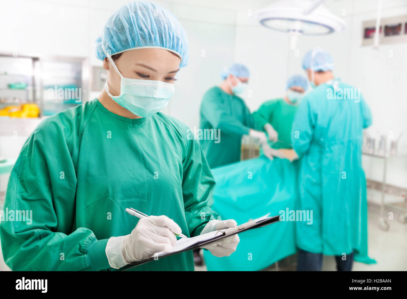 woman Surgeons writing records on form Stock Photo - Alamy