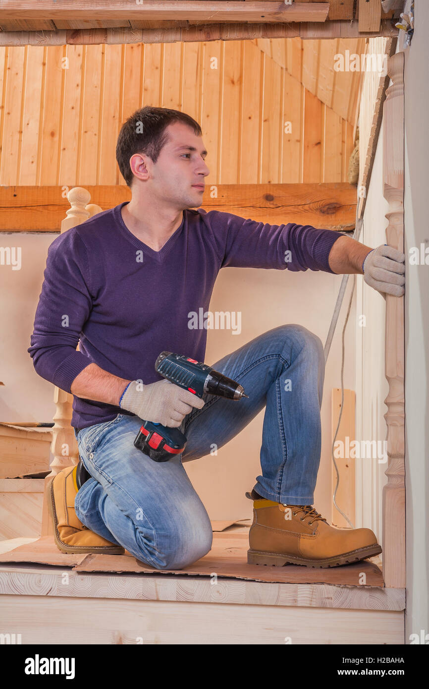 worker sitting and holding cordless drill Stock Photo - Alamy