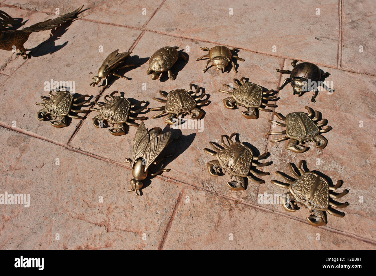 Golden metal figures of sea crabs, scarab beetle Stock Photo - Alamy