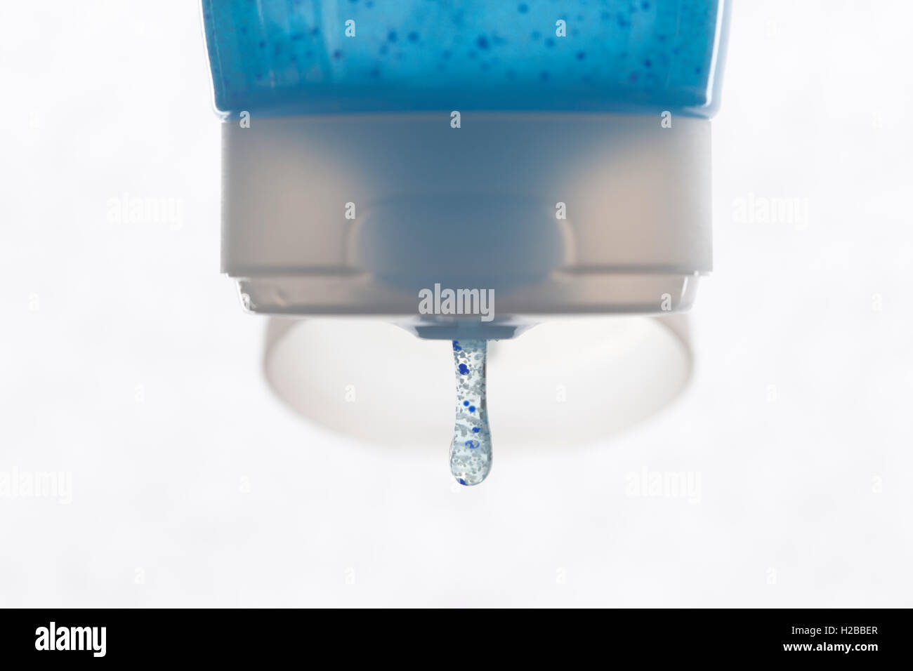 Tube of face scrub containing microbeads. Blue tube on a white ...