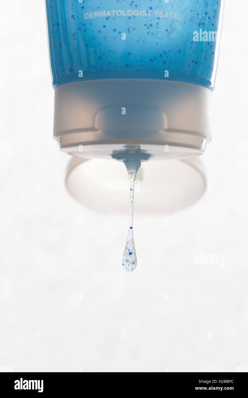 Tube of face scrub containing microbeads. Blue tube on a white ...