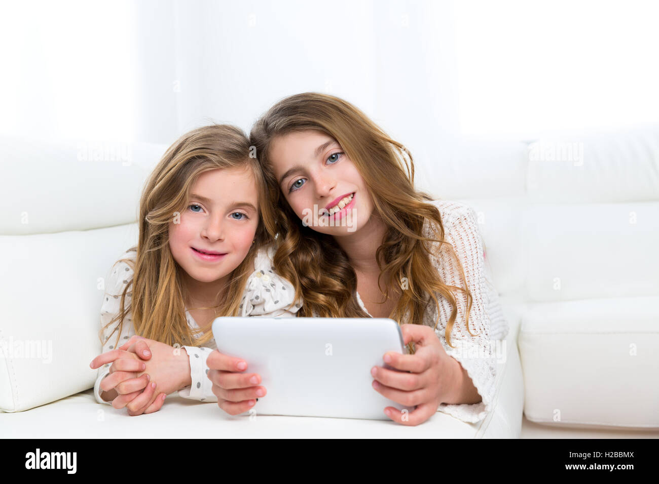 Children friends kid girls playing together with tablet pc Stock Photo ...