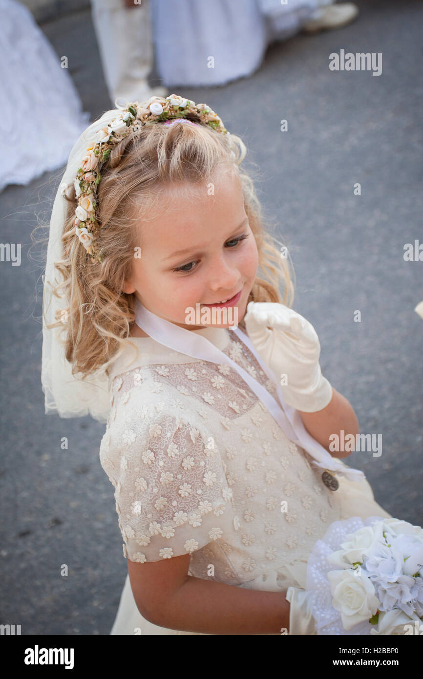 Girl in holy communion dress and veil Stock Photo - Alamy