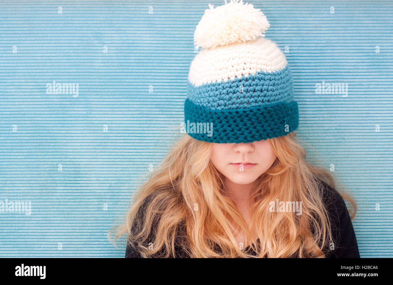 Girl with hat pulled over her eyes Stock Photo - Alamy