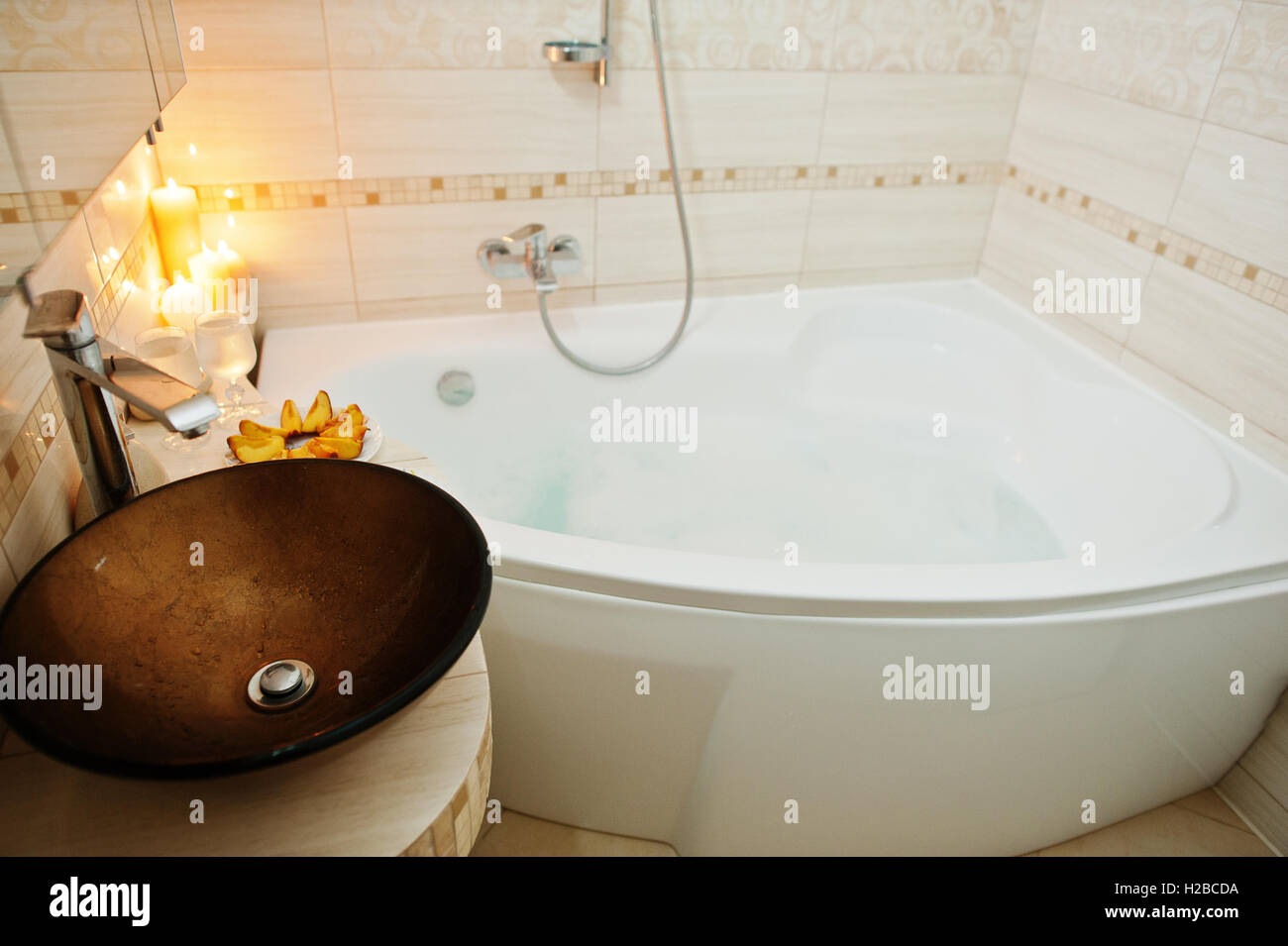 Modern washbasin in bathroom with burning candles Stock Photo - Alamy