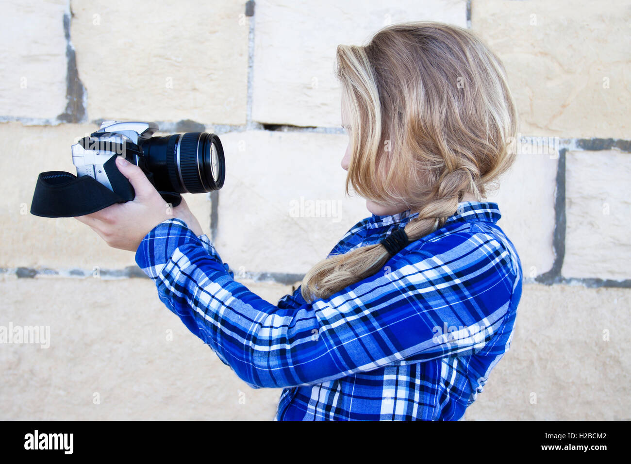 Cool kid holding a camera taking a photo of herself Stock Photo - Alamy