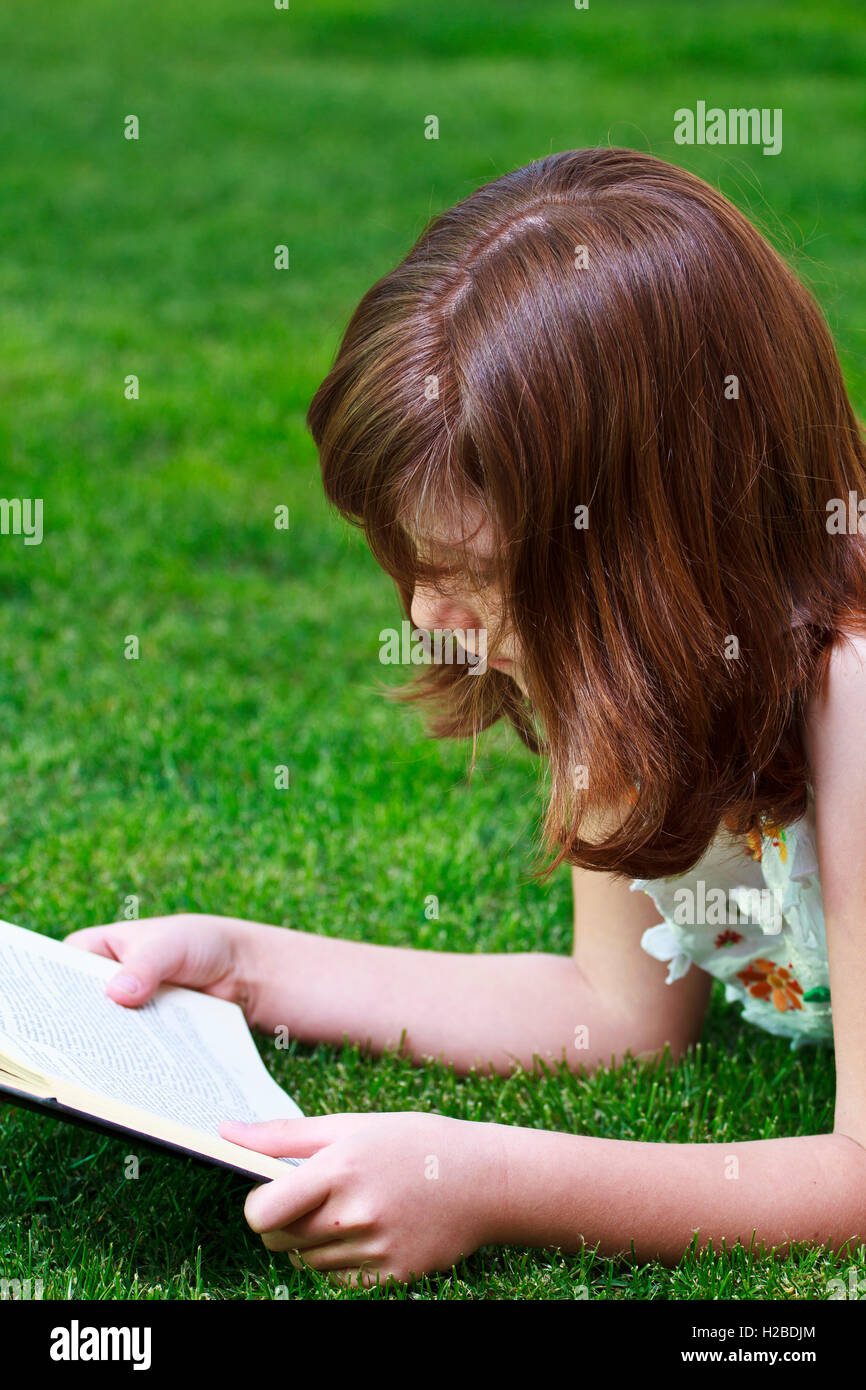 Education.Young beautiful girl reading a book outdoor Stock Photo - Alamy
