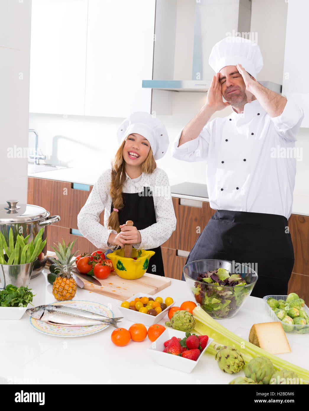 Funny chef master and junior kid girl at cooking school crazy Stock ...