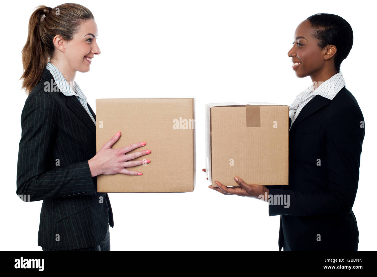 Young business womans holding small boxes Stock Photo - Alamy