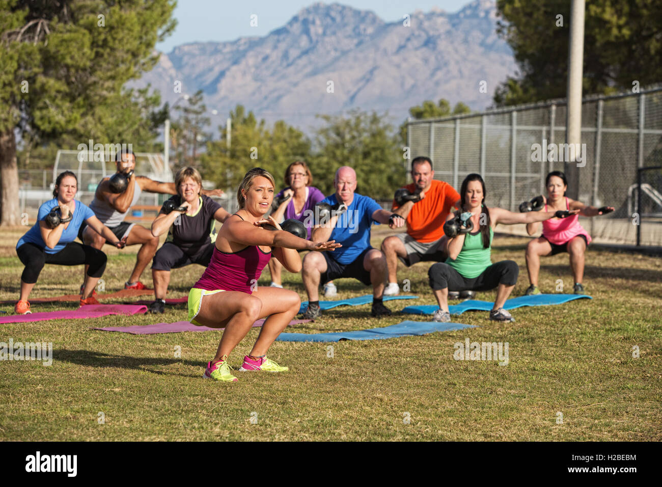 Fitness Class Squatting Stock Photo - Alamy