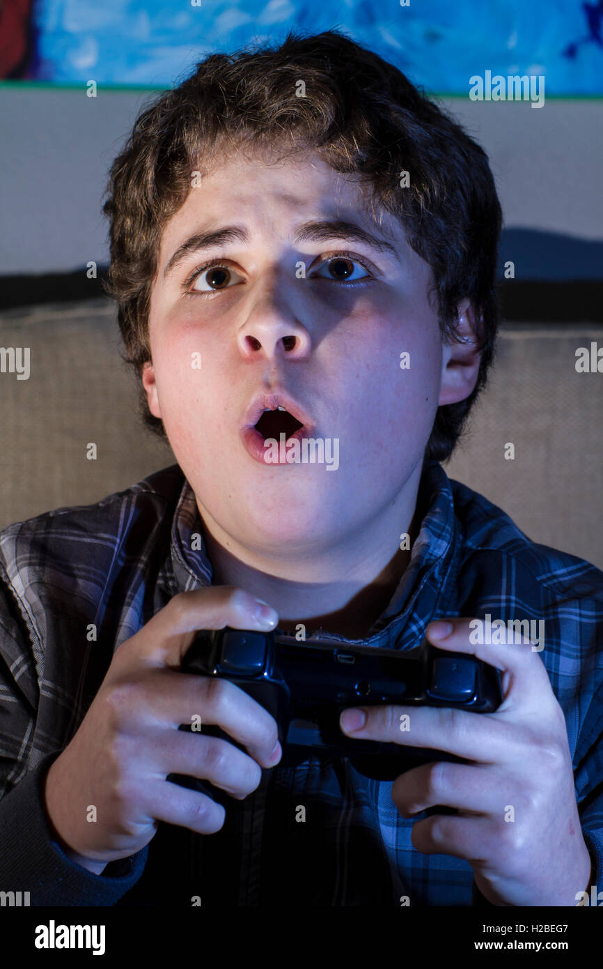Technology. boy with joystick playing computer game at home Stock Photo ...
